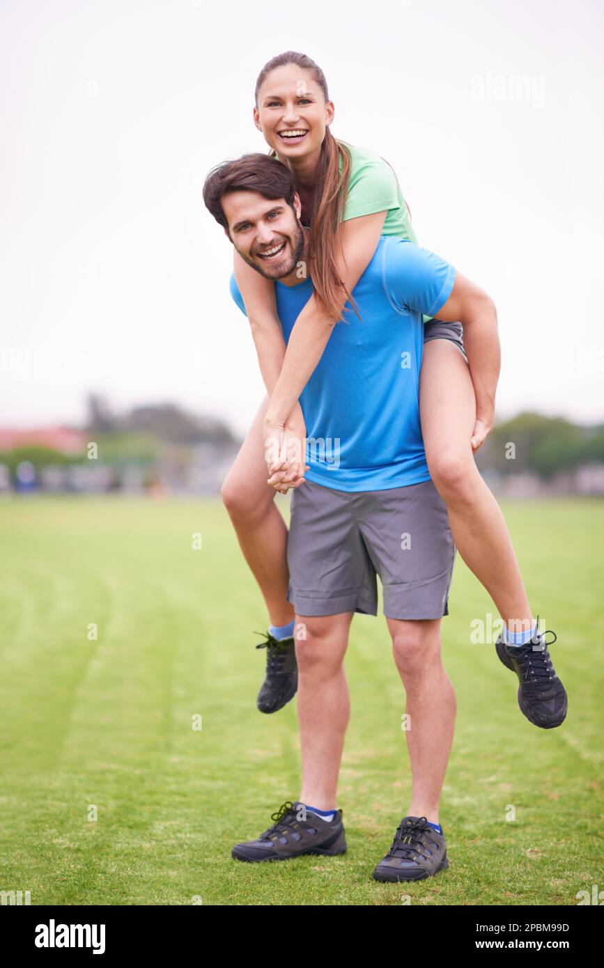 We always have fun together. a young man playfully carrying his ...