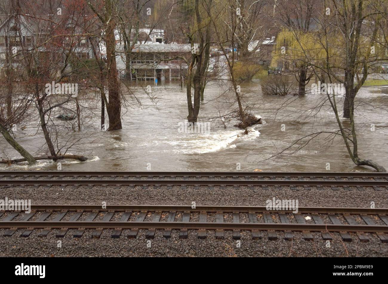 The Norwalk River overflows and floods some businesses in Wilton, Conn ...
