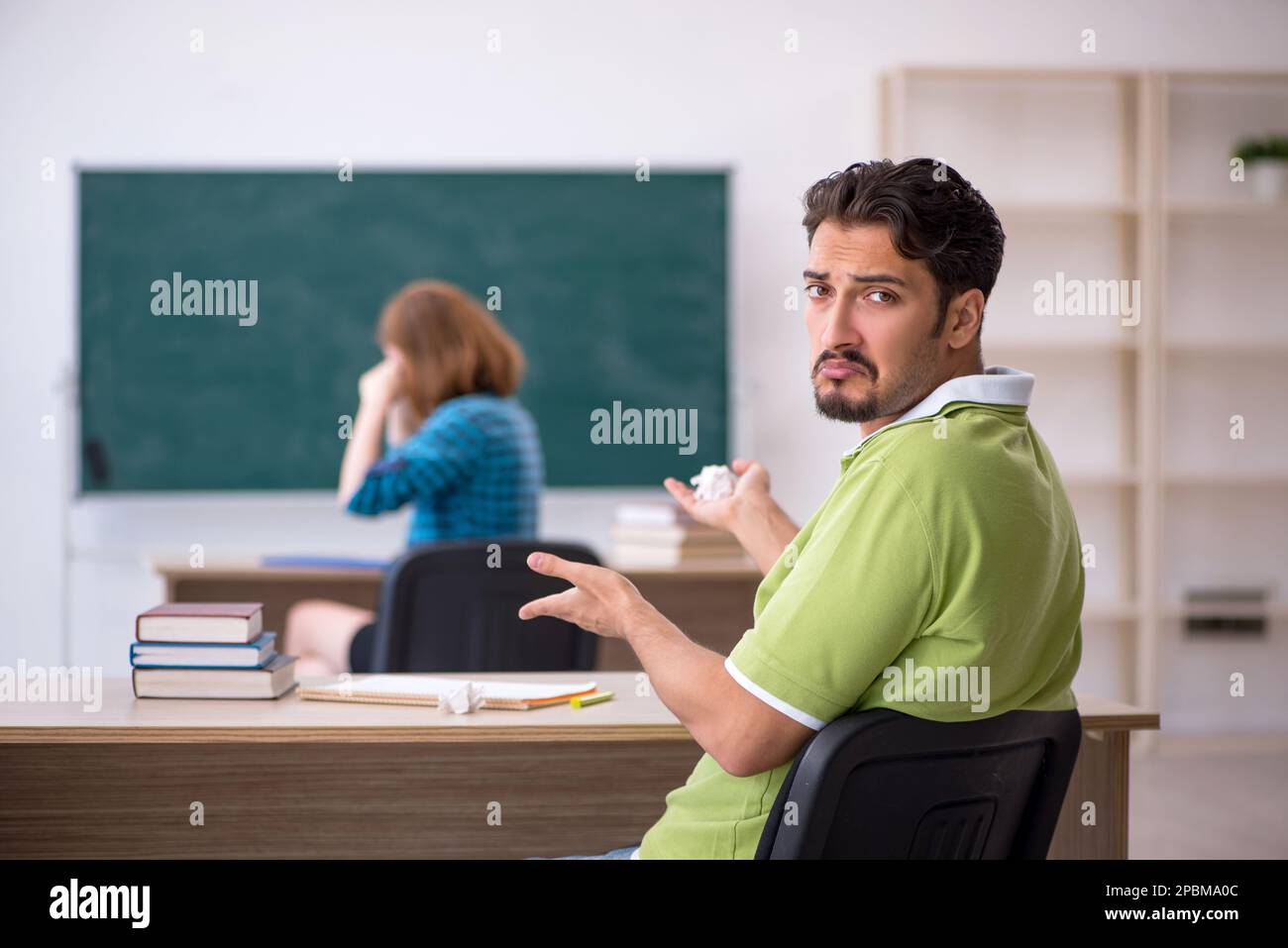 Two students having fun during the lesson Stock Photo - Alamy