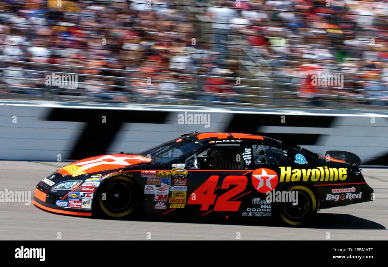 Juan Pablo Montoya of Colombia drives through turn four at the NASCAR ...