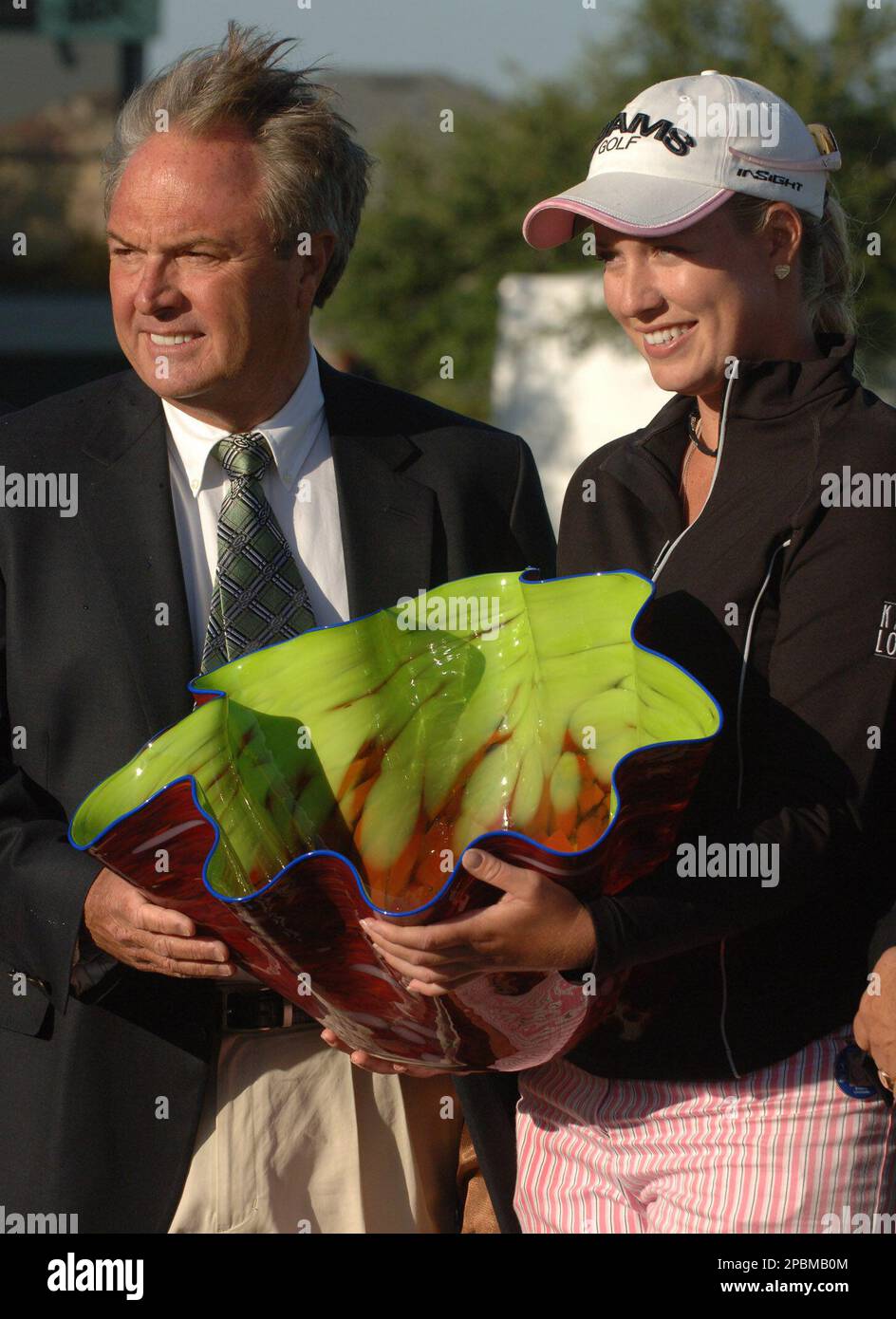 Brittany Lincicome, right, holds the winner's trophy with The Ginn ...