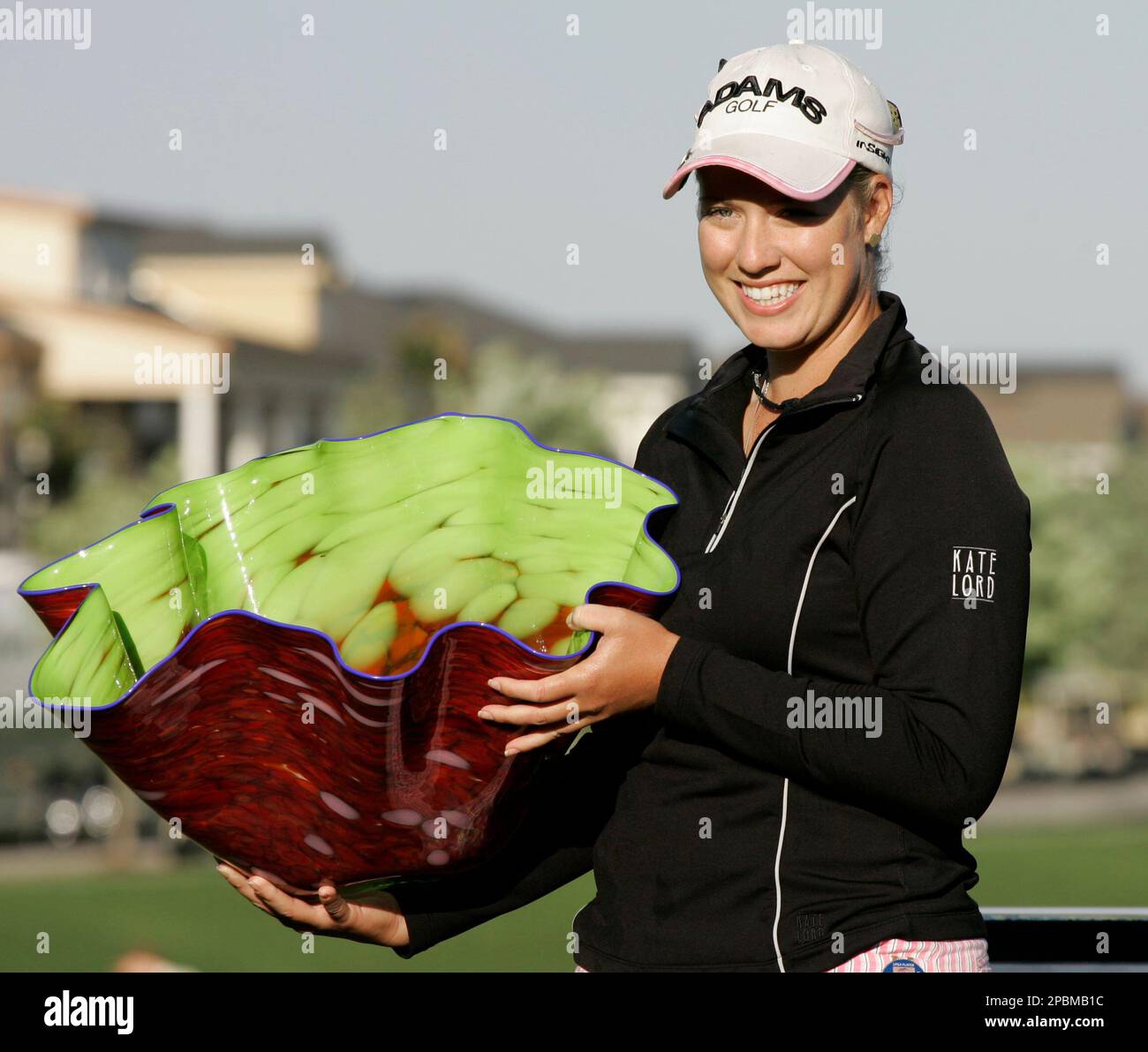 Brittany Lincicome holds the trophy after winning the Ginn Open LPGA ...