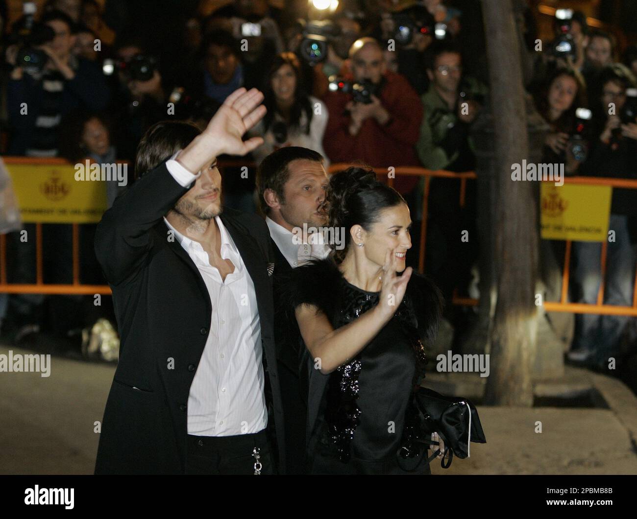 U.S. actress Demi Moore, right, waves with her husband U.S. actor ...