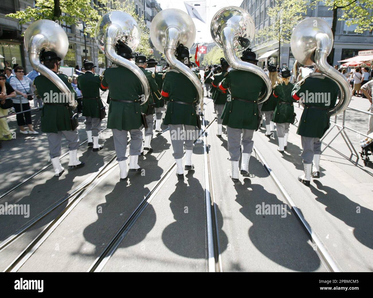A traditional Swiss brass band marches in downtown Zurich during the so ...