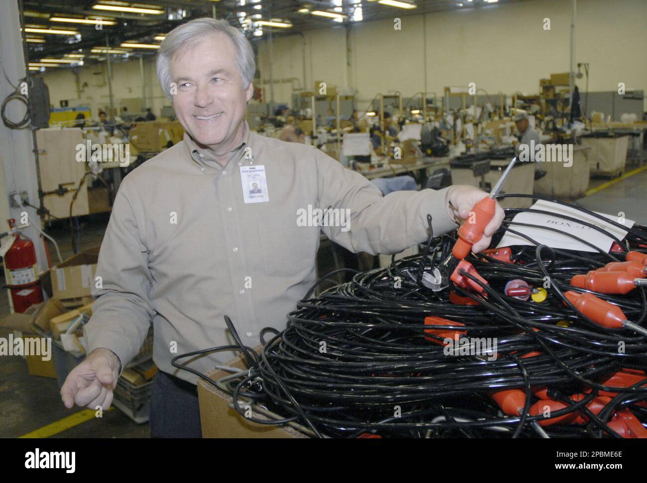 Gary Owens, President and CEO of OYO Geospace Company, stops at a box ...