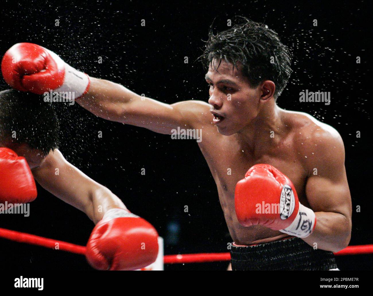 Bernabe Concepcion, right, of the Phillipines, lands a punch on ...