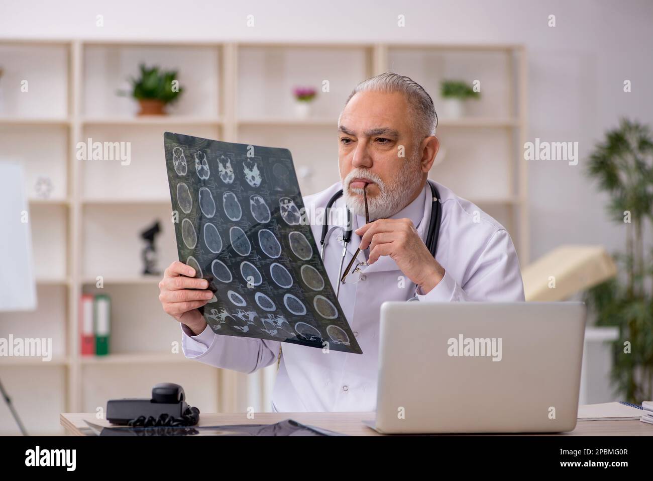 Old doctor radiologist working at the hospital Stock Photo - Alamy