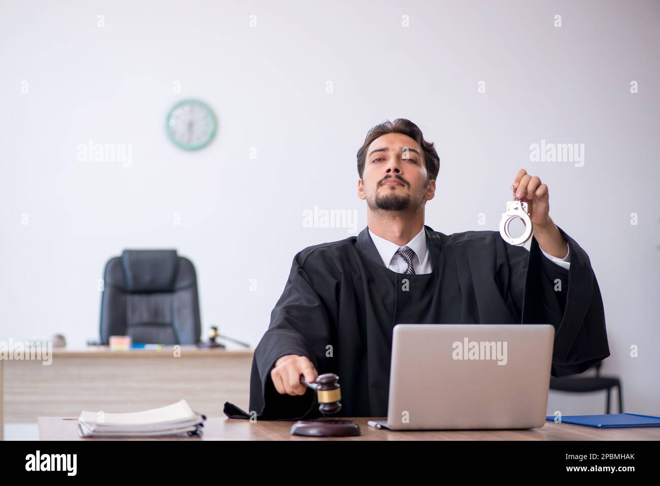 Young judge working in the courthouse Stock Photo - Alamy