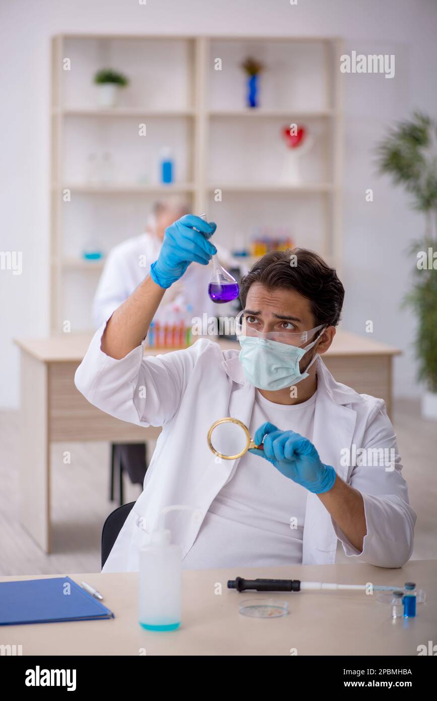 Two chemist working at the lab Stock Photo - Alamy