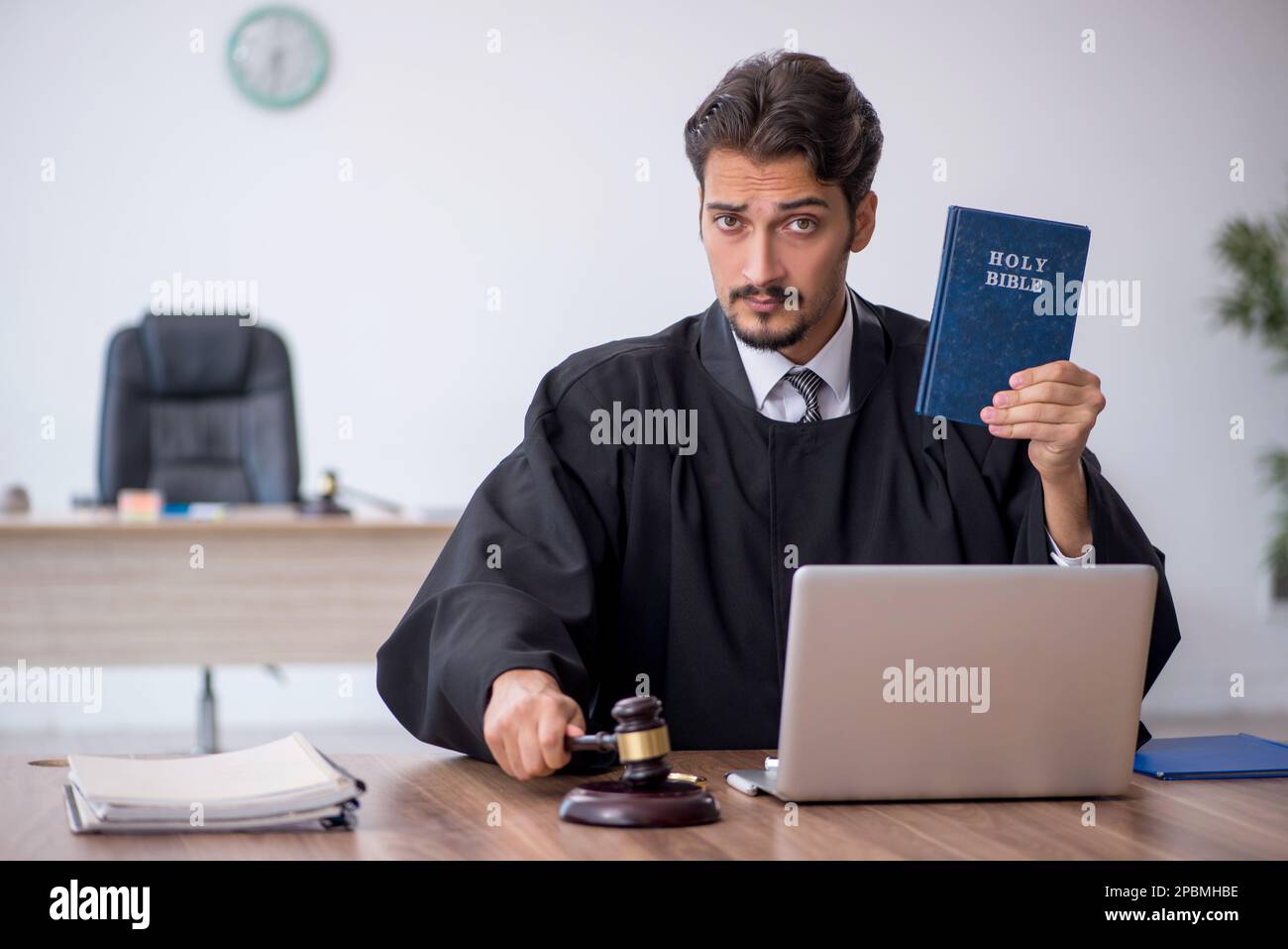 Young judge taking oath on holly bible Stock Photo - Alamy