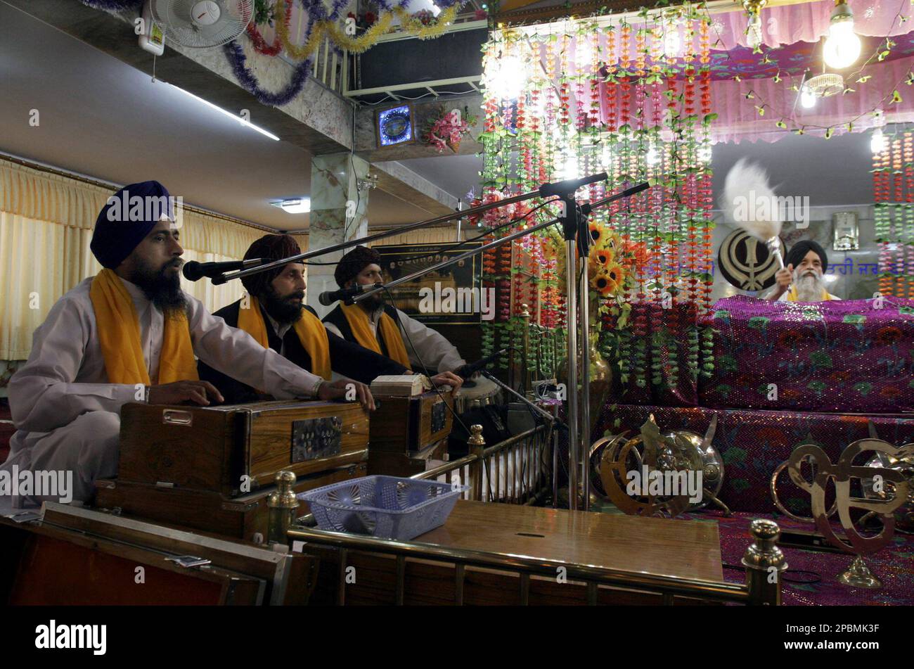 Sikh devotees, playing music, sing religious songs during the Baisakhi ...