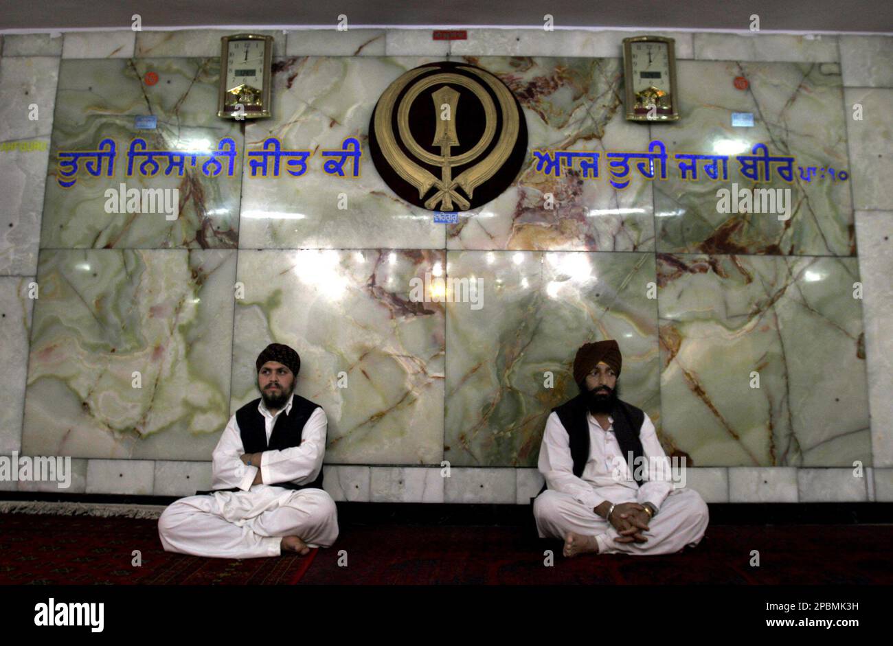 With Indian poem showing the words to the god, Sikh devotee men are ...