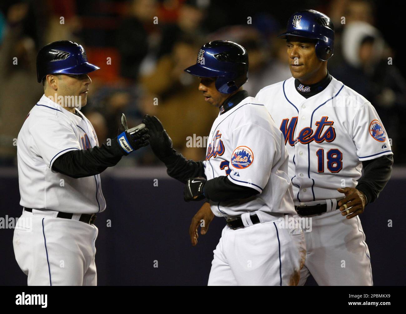 New York Mets' Damion Easley, center, is greeted by Paul Lo Duca, left ...