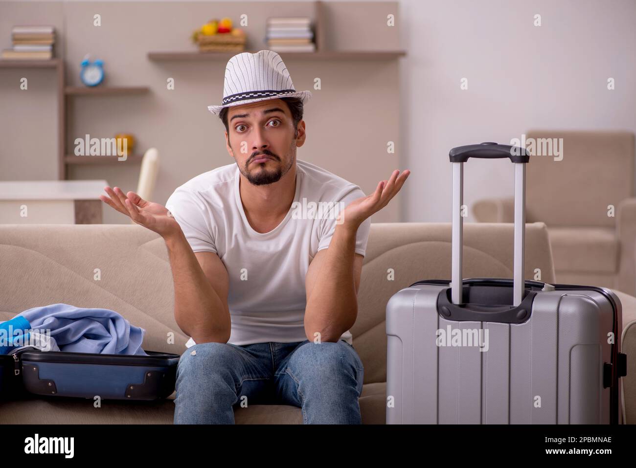 Young male student preparing for trip at home Stock Photo - Alamy