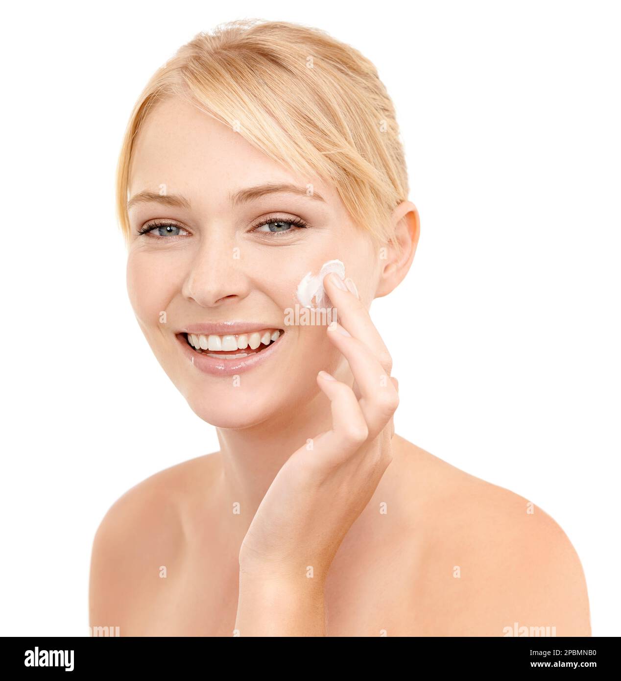 Restoring her skins moisture...Studio shot of a young woman applying ...