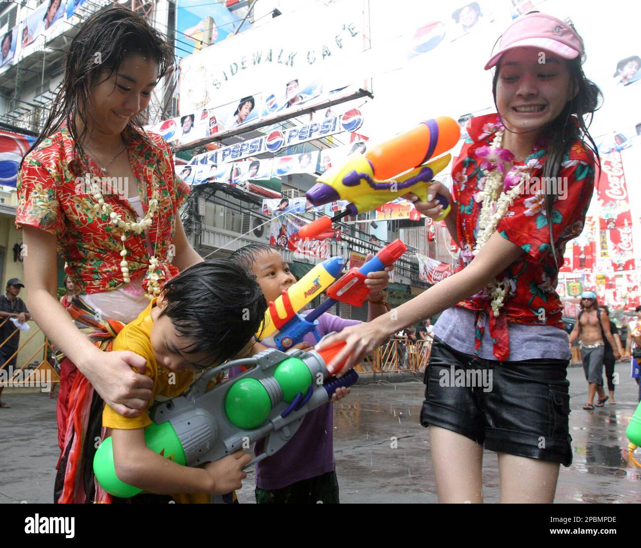 Thai women and boys play with water guns in Bangkok on Thursday, April ...