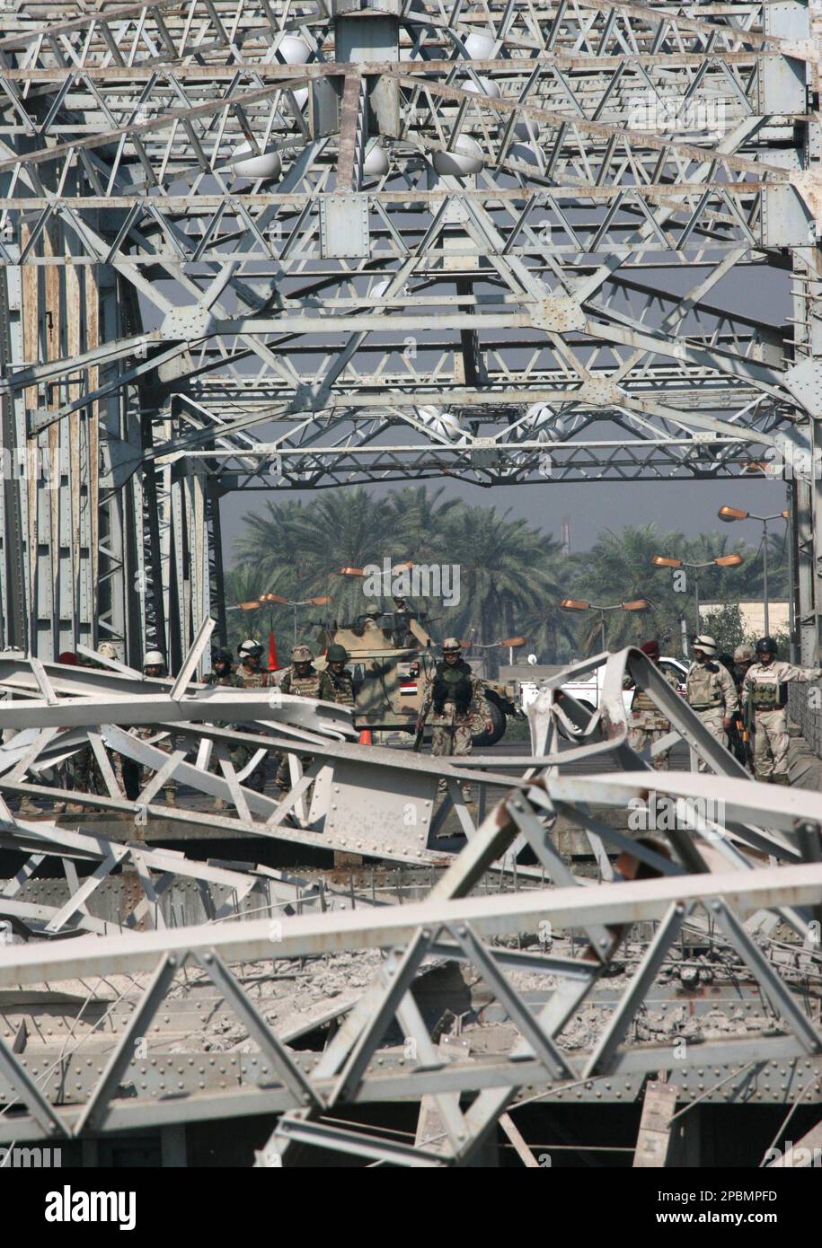 Iraqi army blocks way to a collapsed bridge in Baghdad, Iraq, Thursday ...