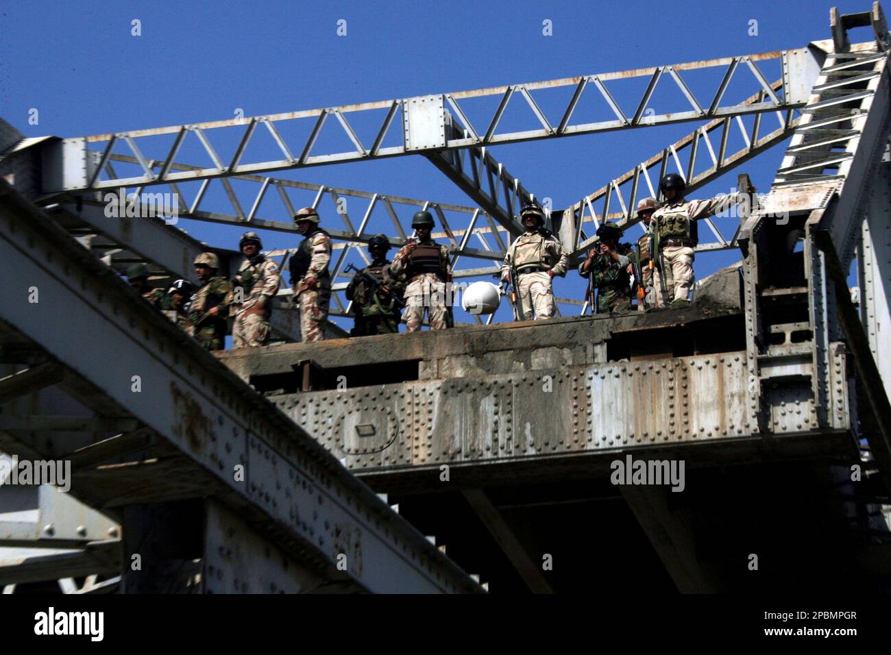 Iraqi army stand on a collapsed bridge in Baghdad, Iraq, Thursday ...