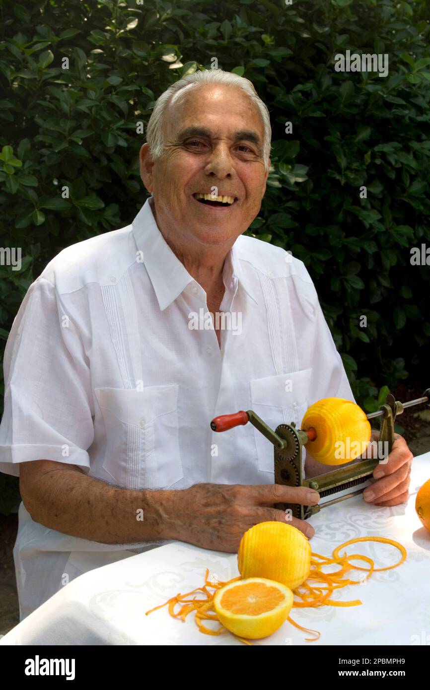 ELDERLY CUBAN MAN PEELING ORANGES MIAMI FLORIDA USA Stock Photo - Alamy