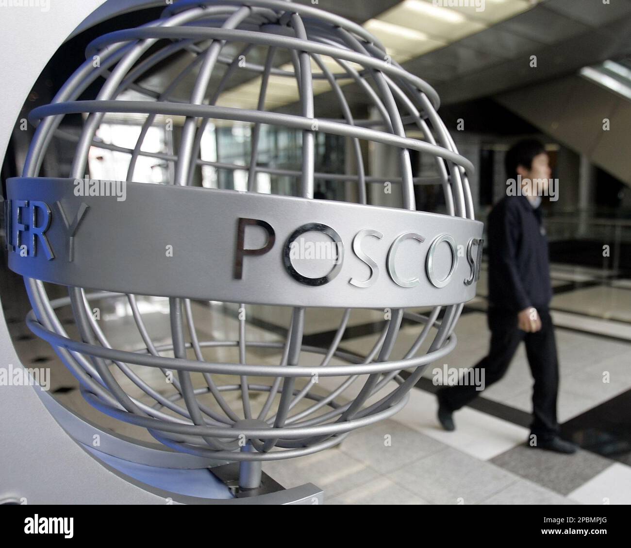 Visitor walk past a sculpture displaying the Posco logo at the company ...