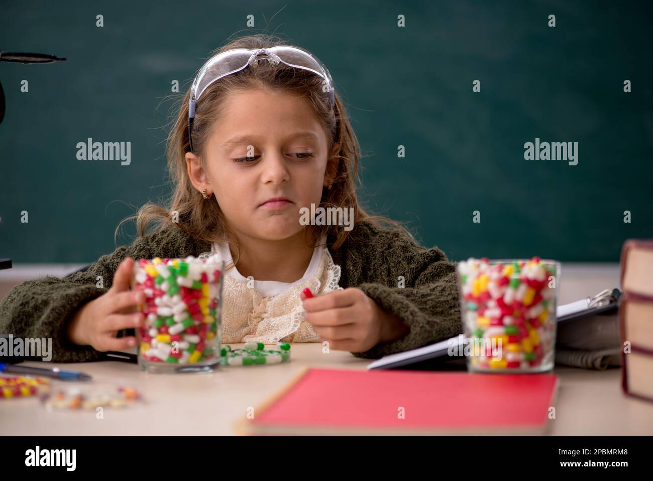 Young small girl chemist in the classroom Stock Photo - Alamy