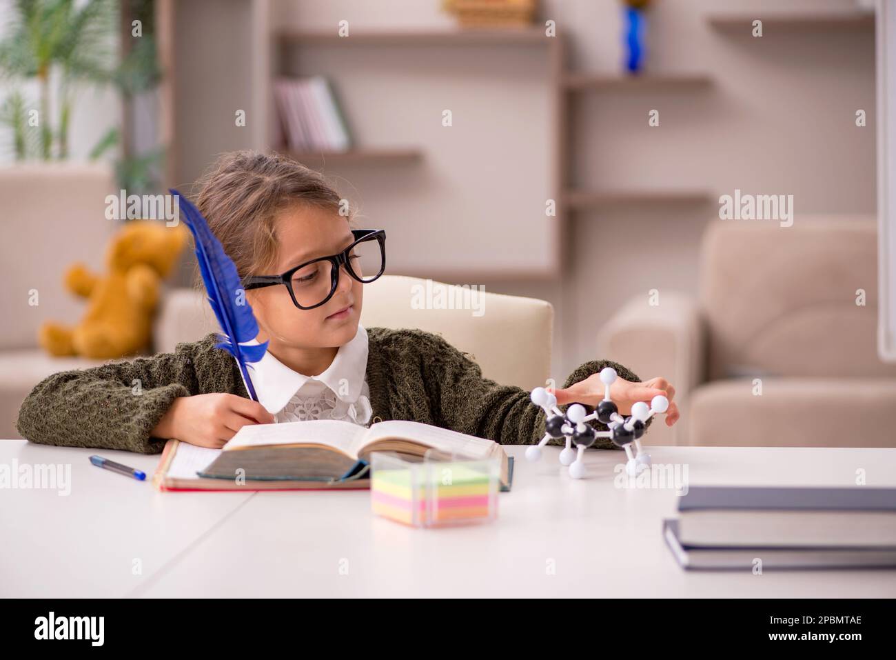 Young small girl studying at home Stock Photo - Alamy
