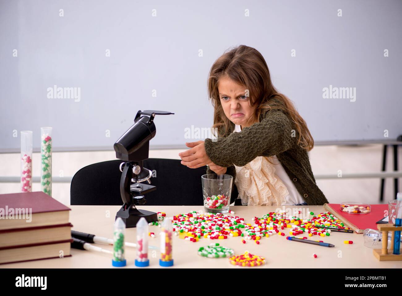 Young small girl chemist in the classroom Stock Photo - Alamy