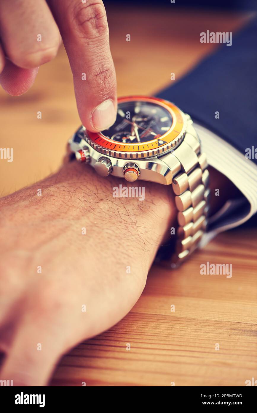 Making sure he sticks to the schedule. a businessman checking the time ...