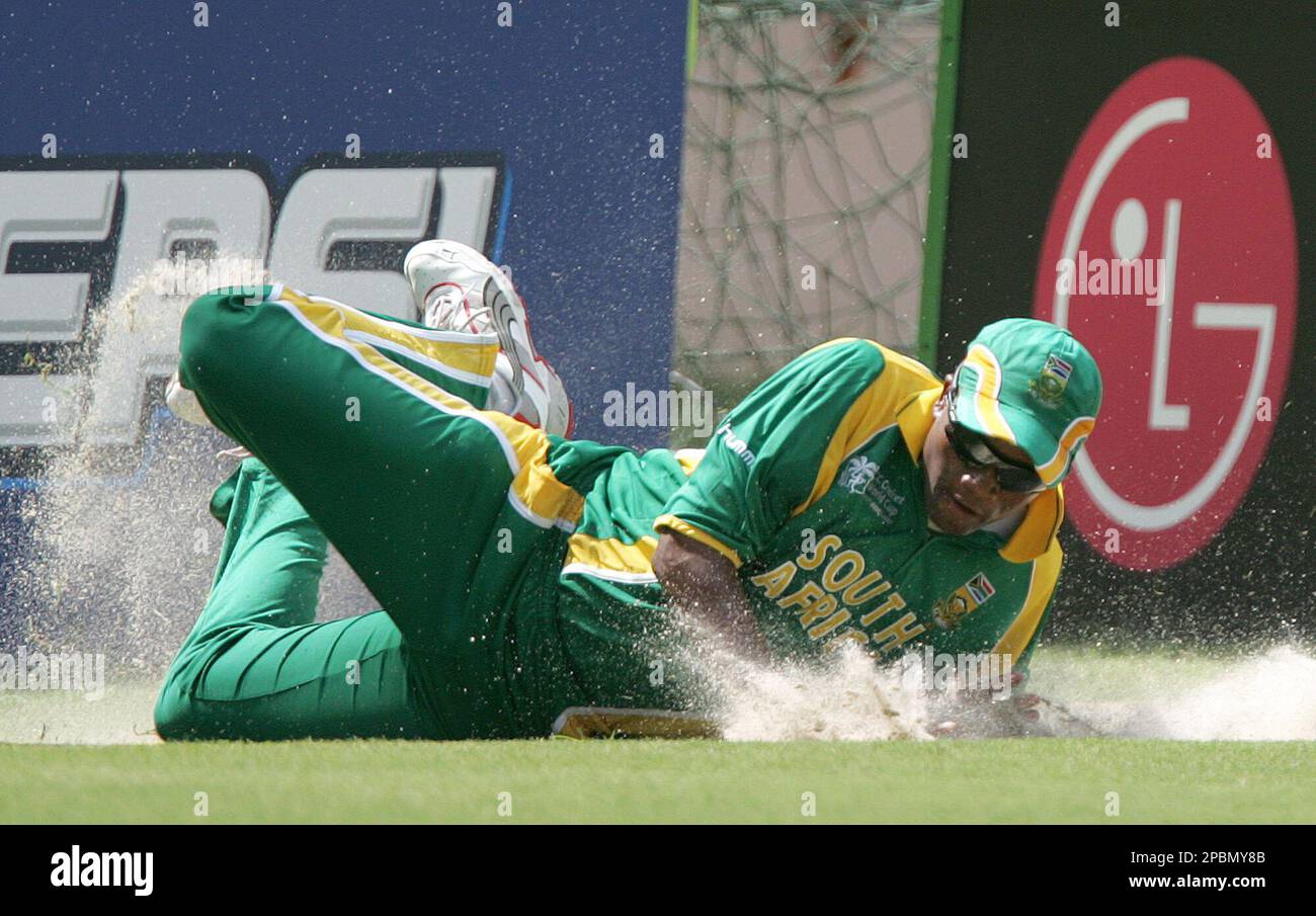 South Africa's fielder Loots Bosman, stumbles while trying to stop a ...