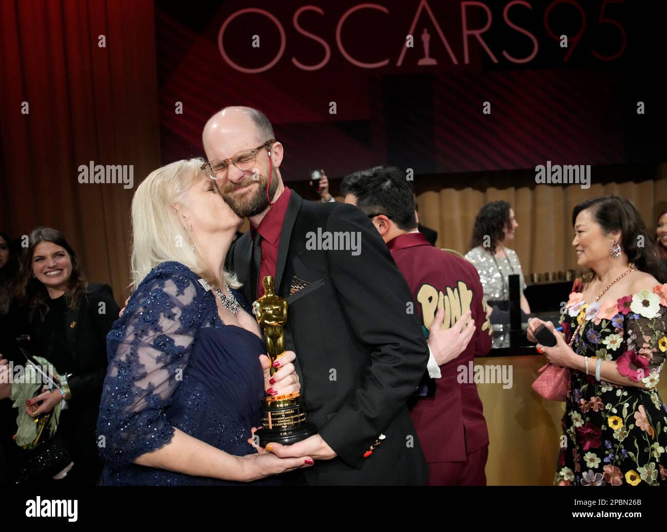 Becky Scheinert, left, kisses her son Daniel Scheinert, winner of best ...
