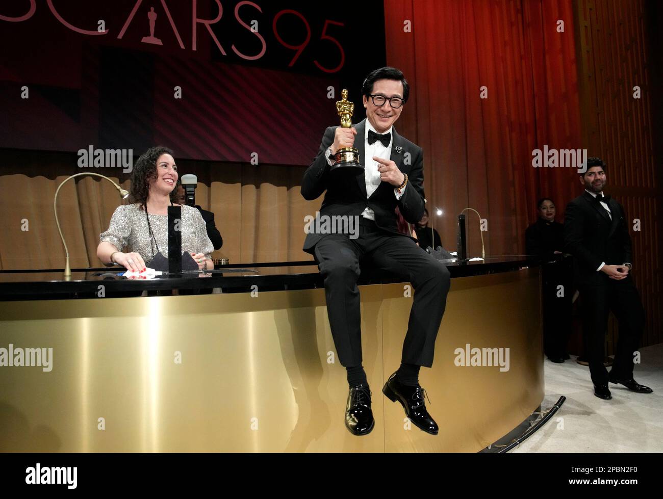 Ke Huy Quan poses with his award for best performance by an actor in a ...