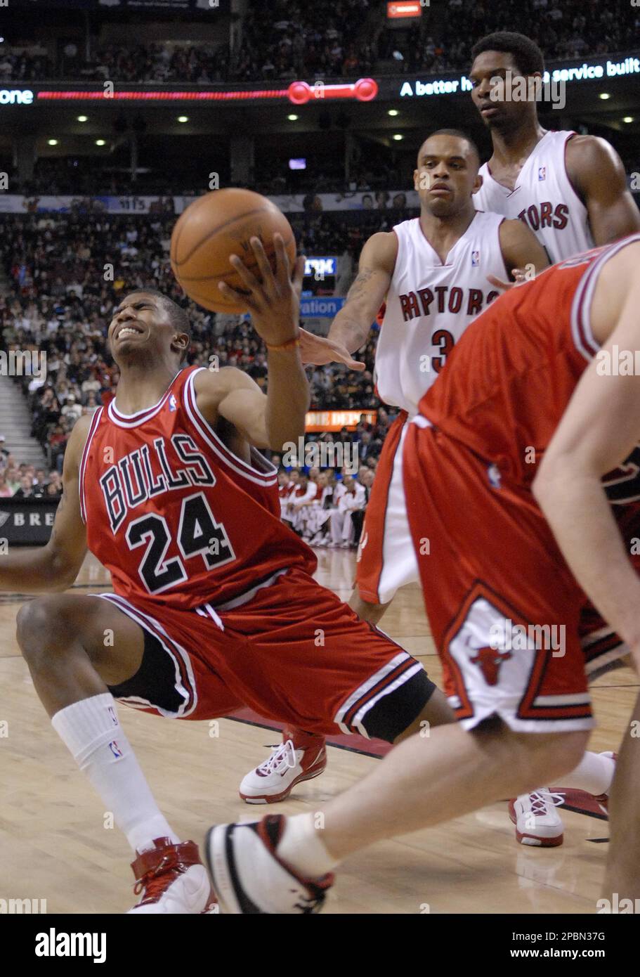 Chicago Bulls' Tyrus Thomas, left, grimaces as he goes down while ...