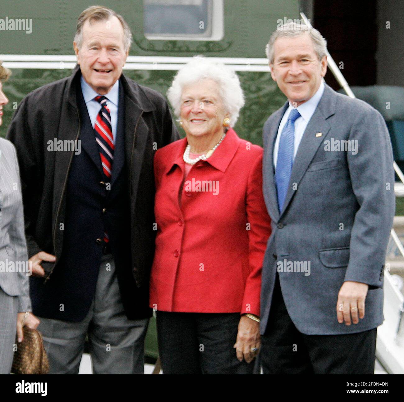 President Bush stands with his father, former President Bush, right ...