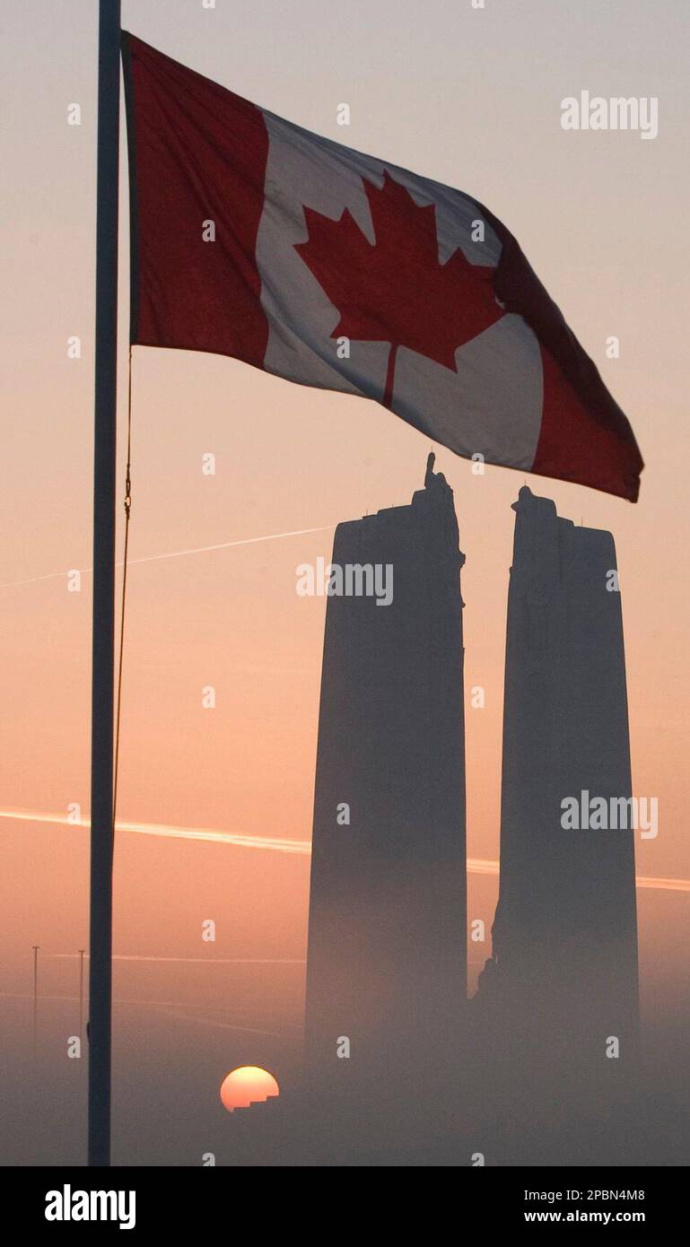 The sun rises as the Canadian flag flies in front of the renovated ...