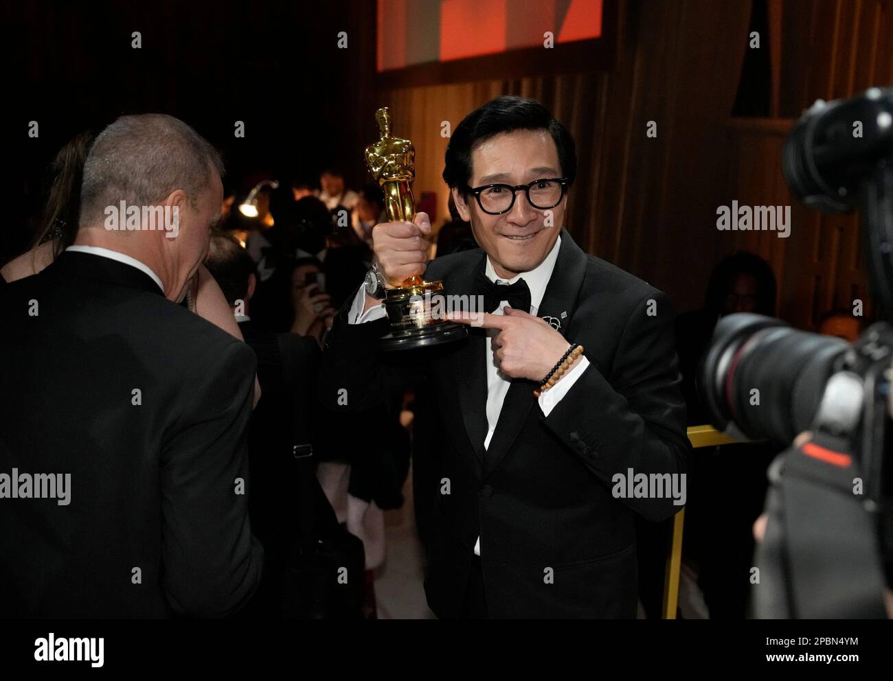 Ke Huy Quan poses with his award for best performance by an actor in a ...