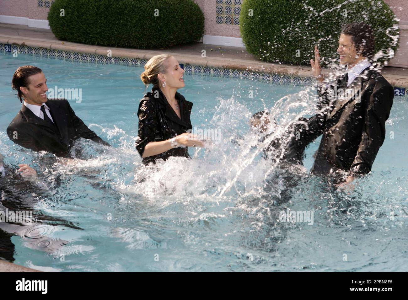 Heidi Klum, center, splashes in a pool with models during a event ...