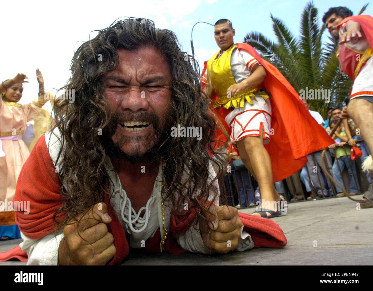 Mario Valencia, dressed as Jesus Christ lays on the ground as he ...