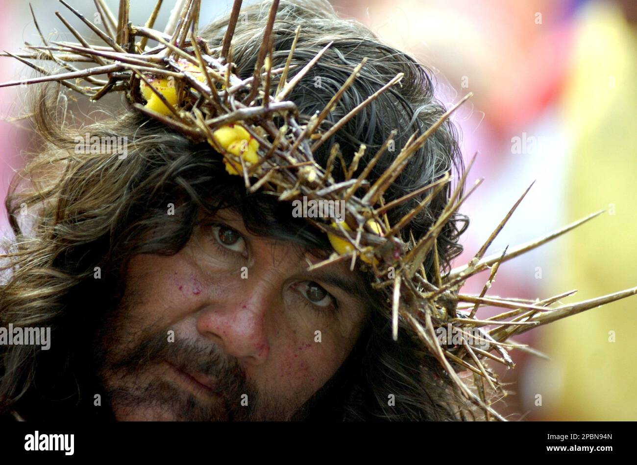 Mario Valencia, dressed as Jesus Christ, reenacts the crucifixion during a Holy Week procession ...