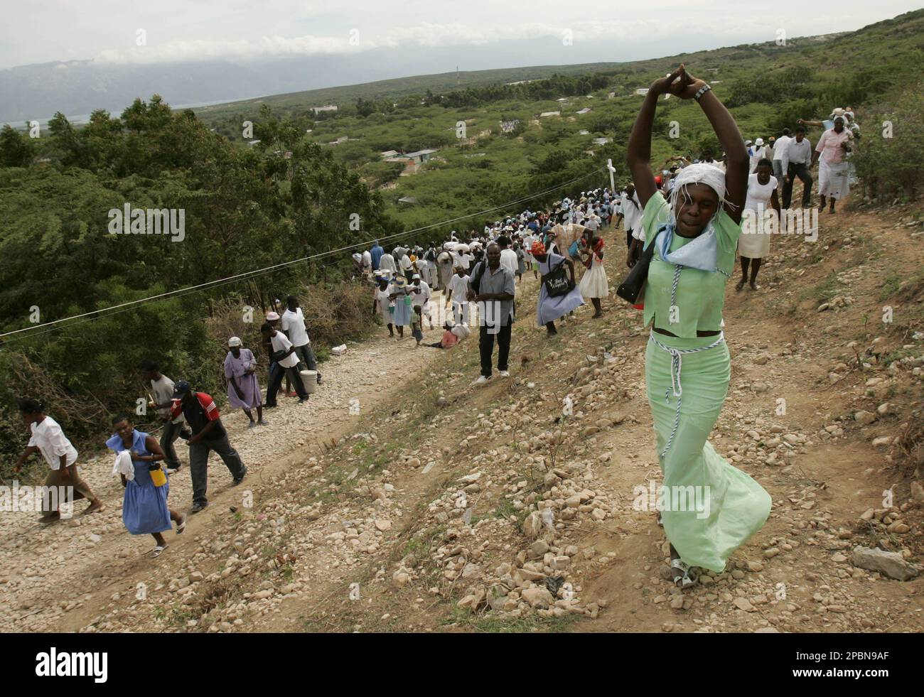 A woman prays as she takes part in a pilgrimage to the mount of ...