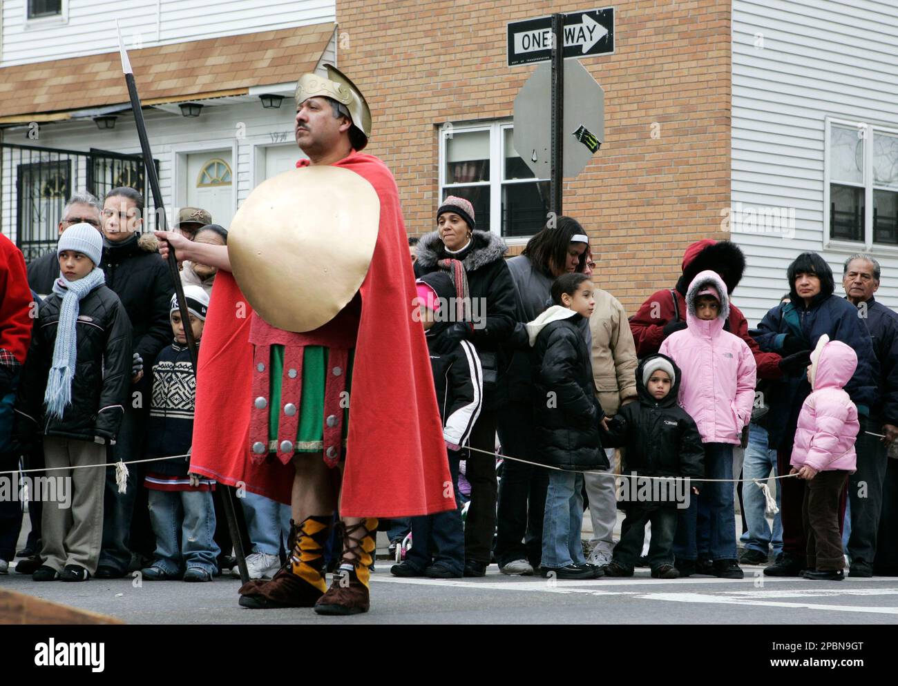 Pedestrians watch a reenactment of the crucifixion of Jesus in the ...
