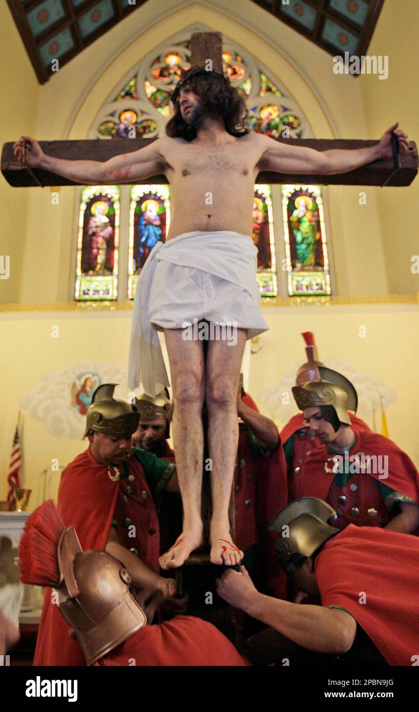 Roman soldiers raise the cross with Jesus Christ, played by Rafael N ...