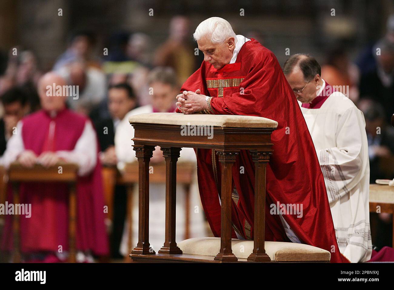Pope Benedict XVI kneels in prayer during a Good Friday ceremony for ...