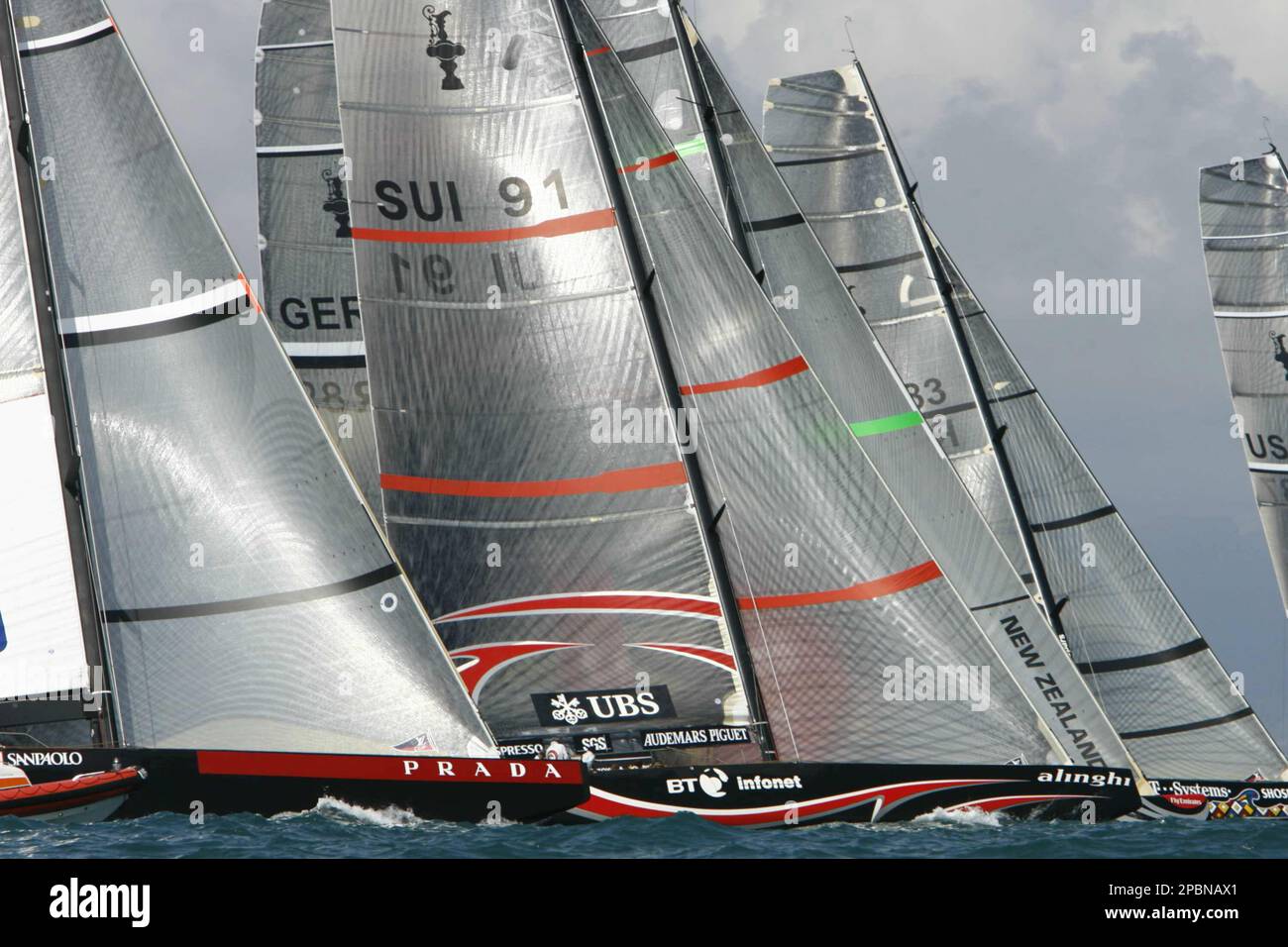 Swiss defender yacht Alinghi, SUI 91, center, sails the fourth fleet ...