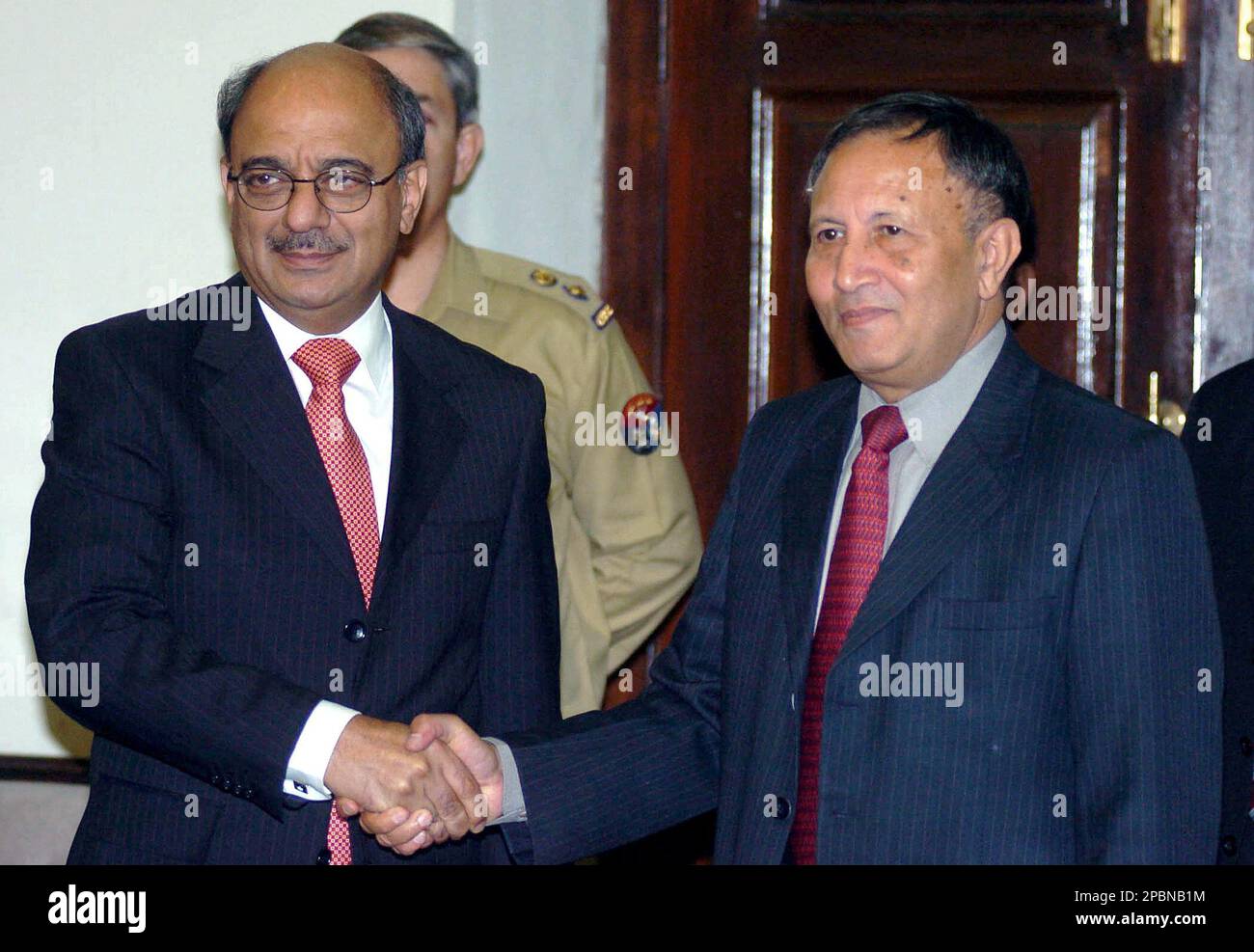 Indian Defense Secretary Shekhar Dutt, right, shakes hand with his ...