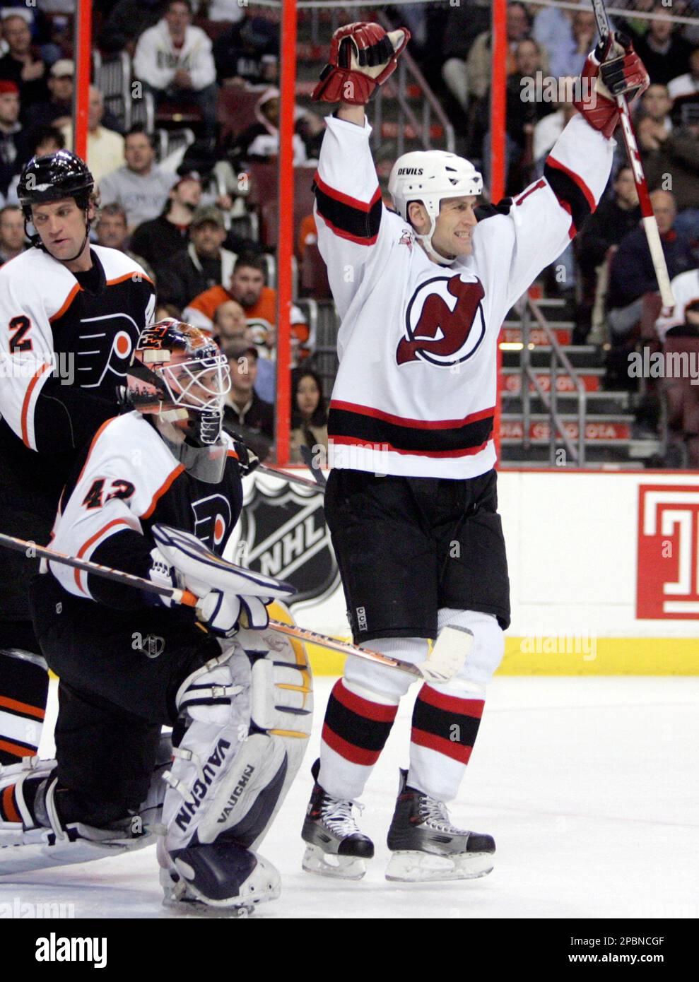 New Jersey Devils' Mike Rupp raises his arms in front of Philadelphia ...