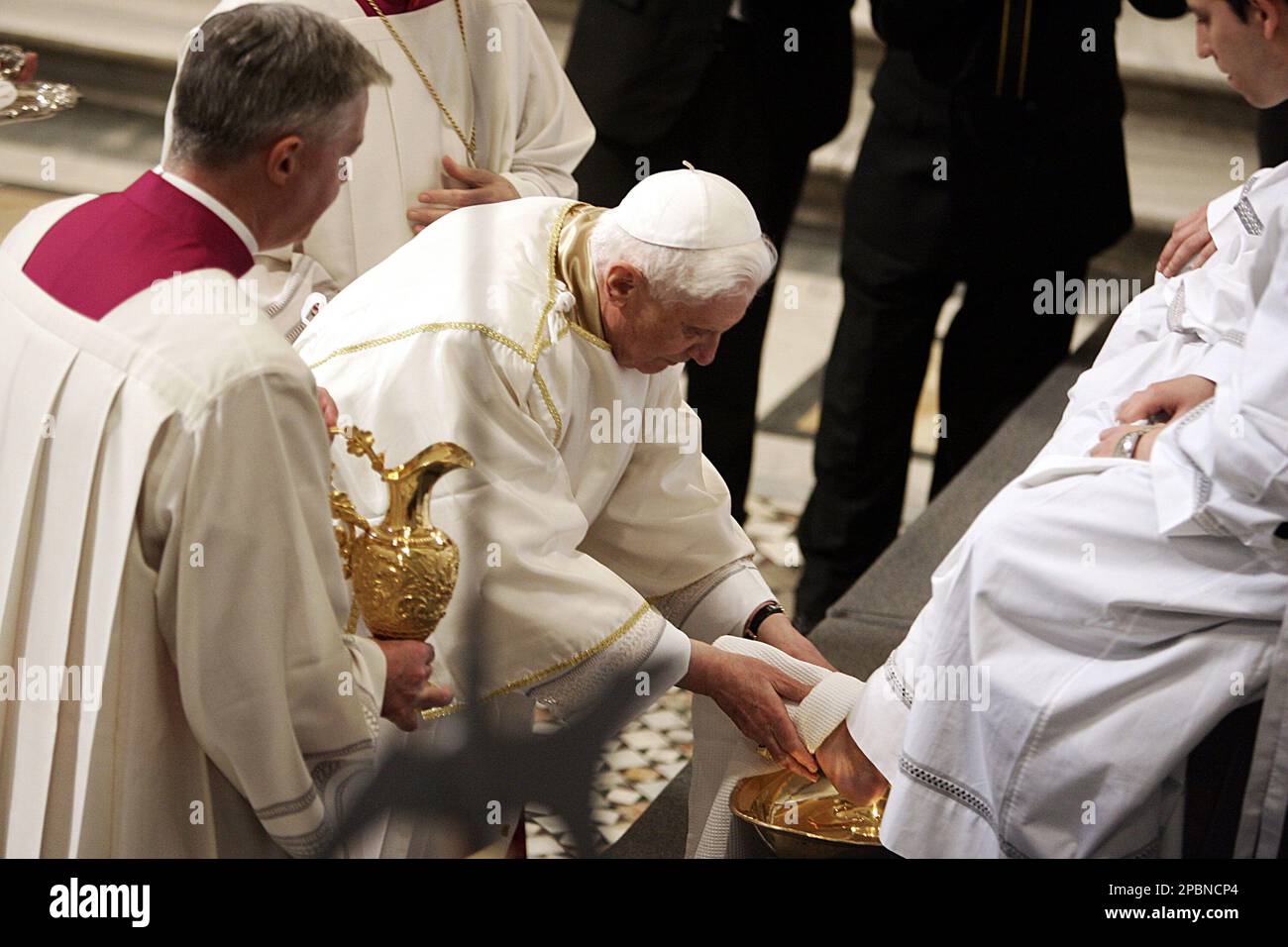 Pope Benedict XVI washes the foot of an unidentified layman in St. John ...