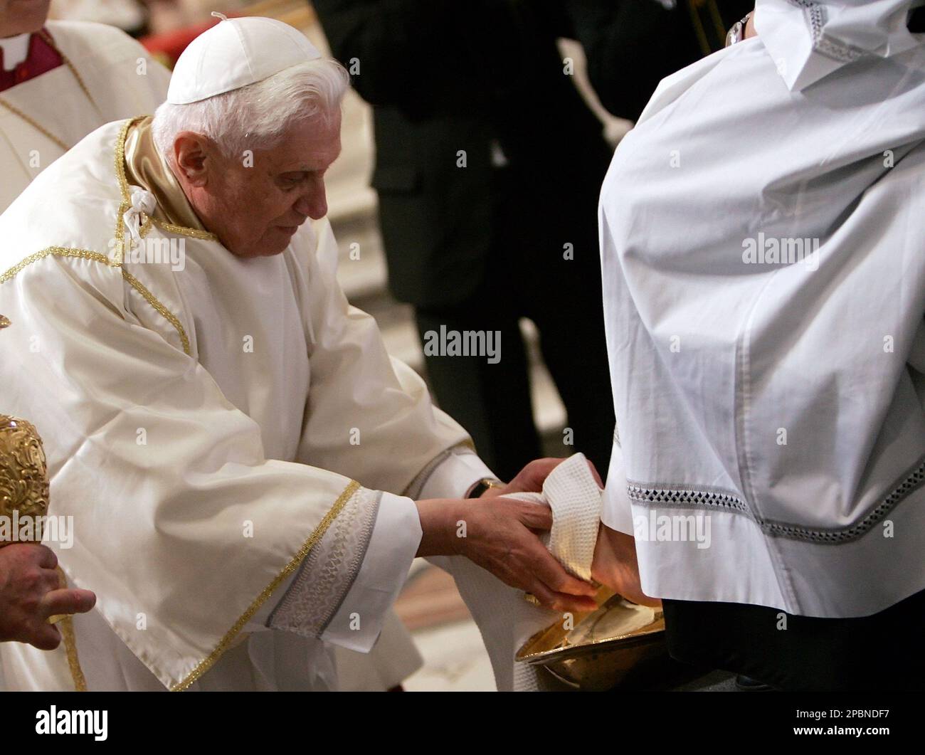 Pope Benedict XVI dries the foot of an unidentified layman, during the ...