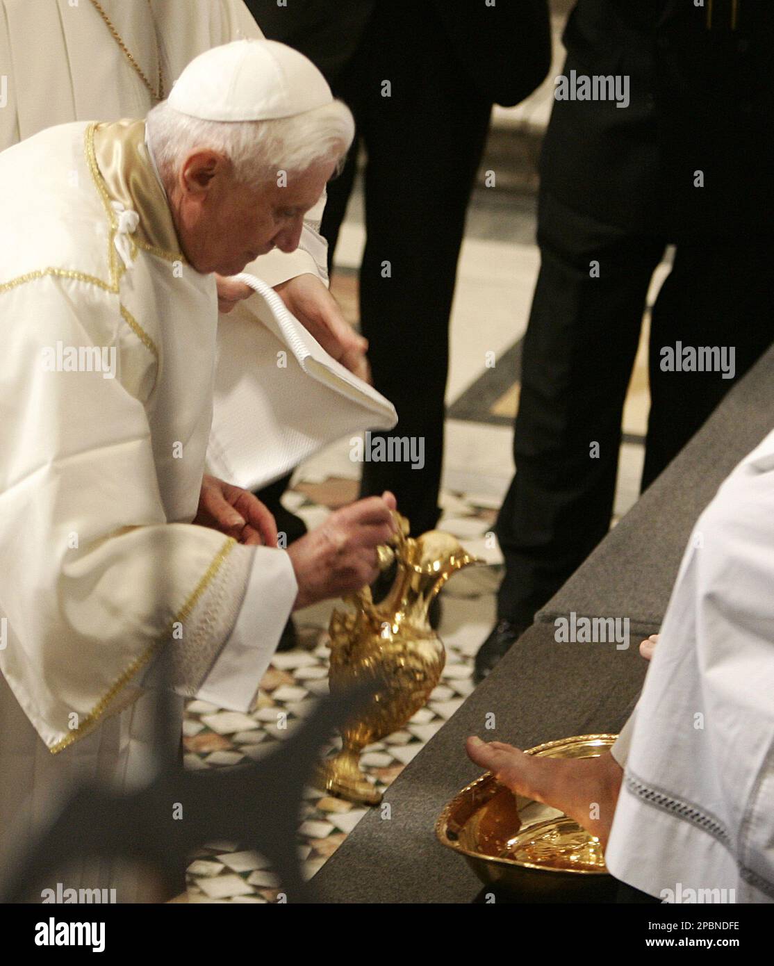 Pope Benedict XVI washes the foot of an unidentified layman in St. John ...