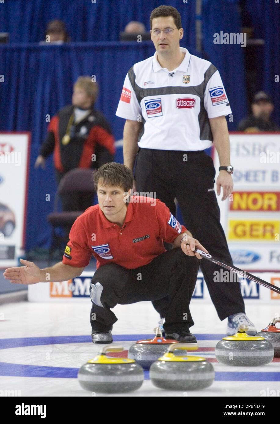 Norways skip Thomas Ulsrud, bottom tries to line up a shot as German ...