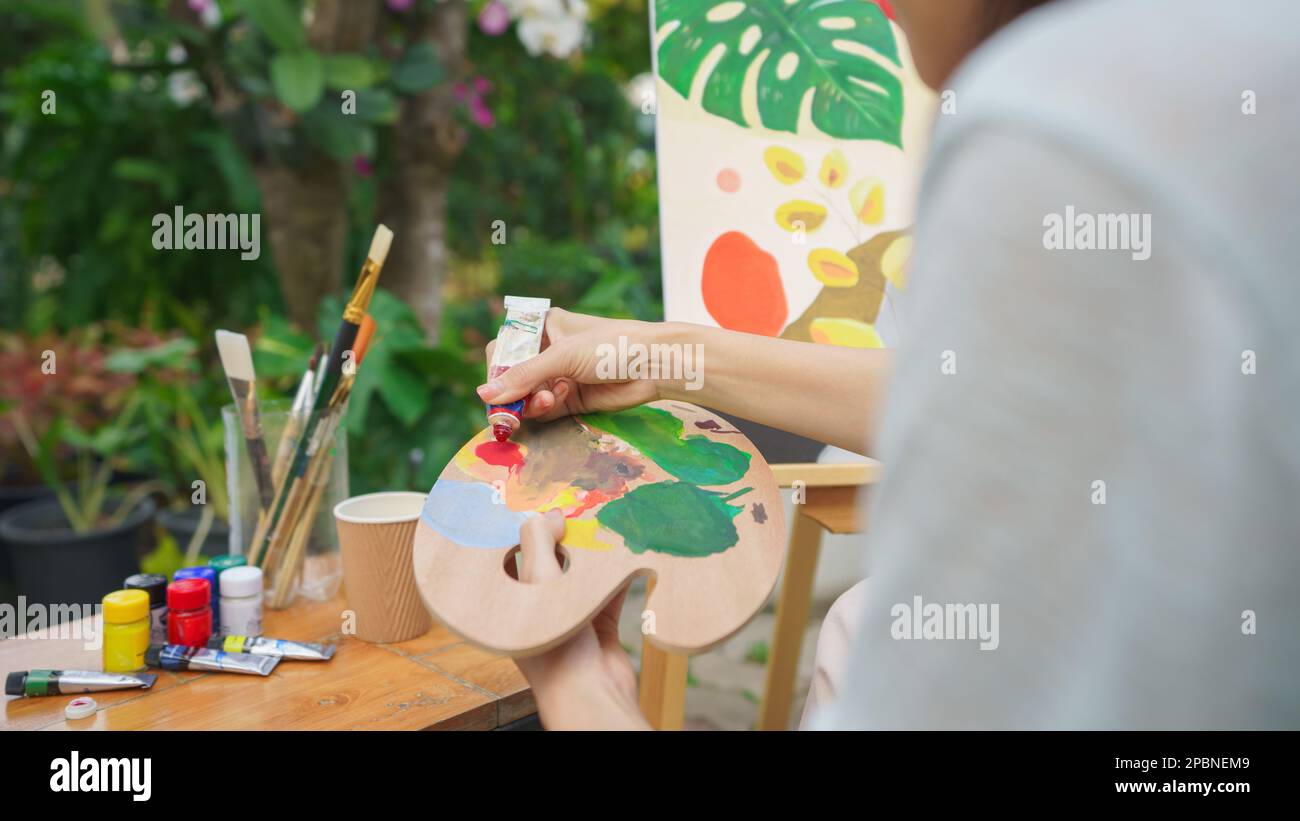 Artist concept, Female artist holds paint tube to mix watercolor on ...